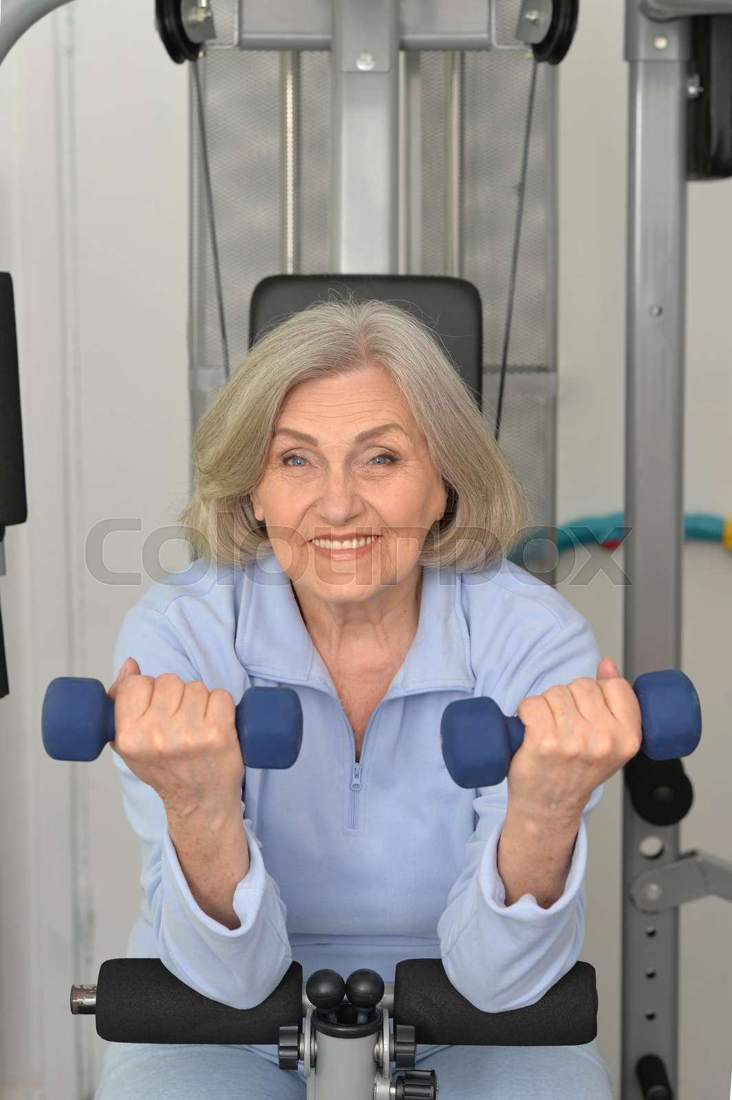Beautiful elderly woman in a gym with dumbbells | Stock image | Colourbox