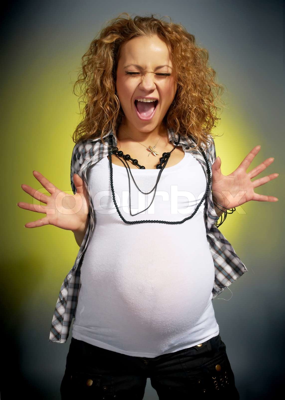 screaming pregnant woman in studio | Stock image | Colourbox