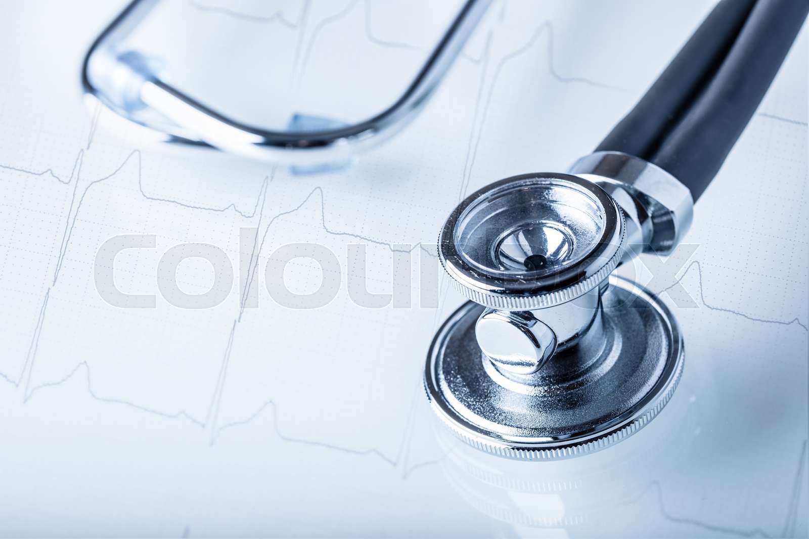 Stethoscope. Stethoscope for heart rate measurement on ekg graph ...