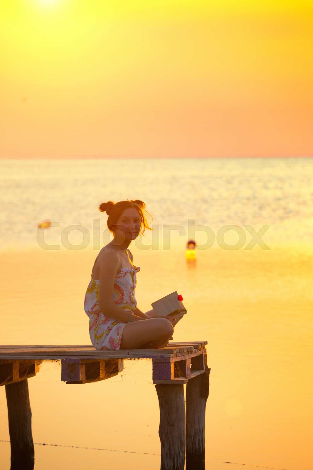 girl reading at the sunset time | Stock image | Colourbox