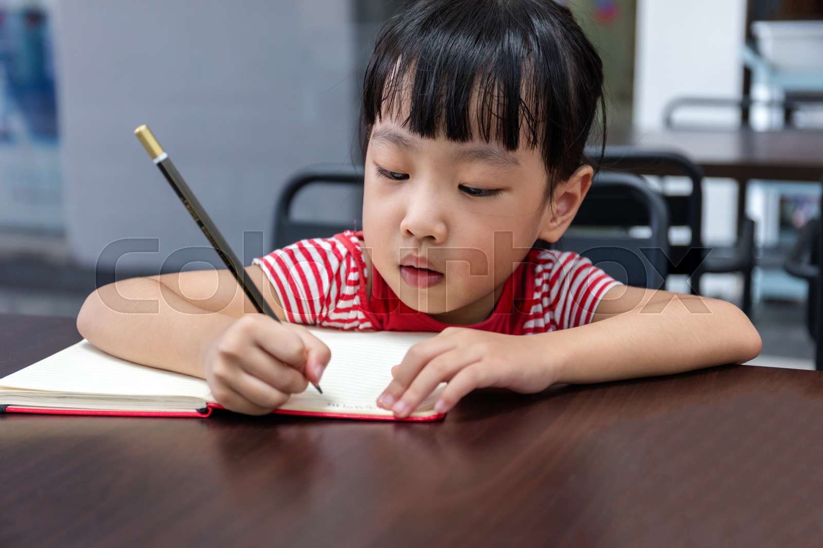 Asian Chinese little girl doing homework | Stock image | Colourbox