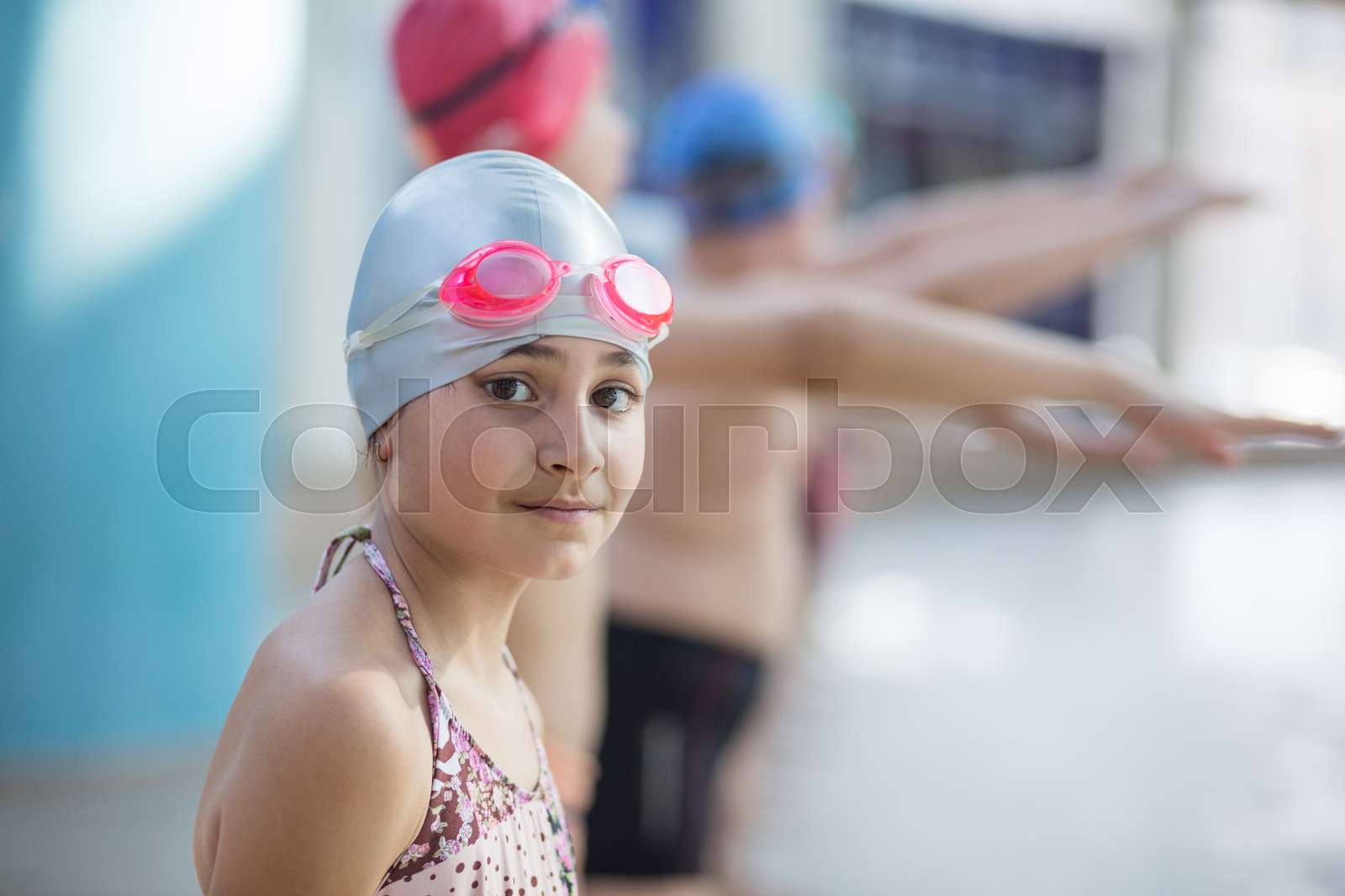 Little girl in googles swim in pool | Stock image | Colourbox