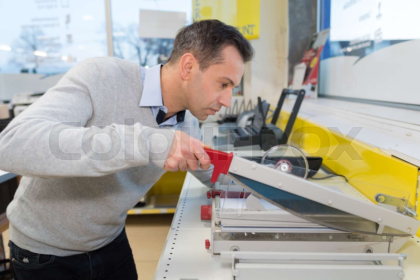 man using guillotine cutter | Stock image | Colourbox