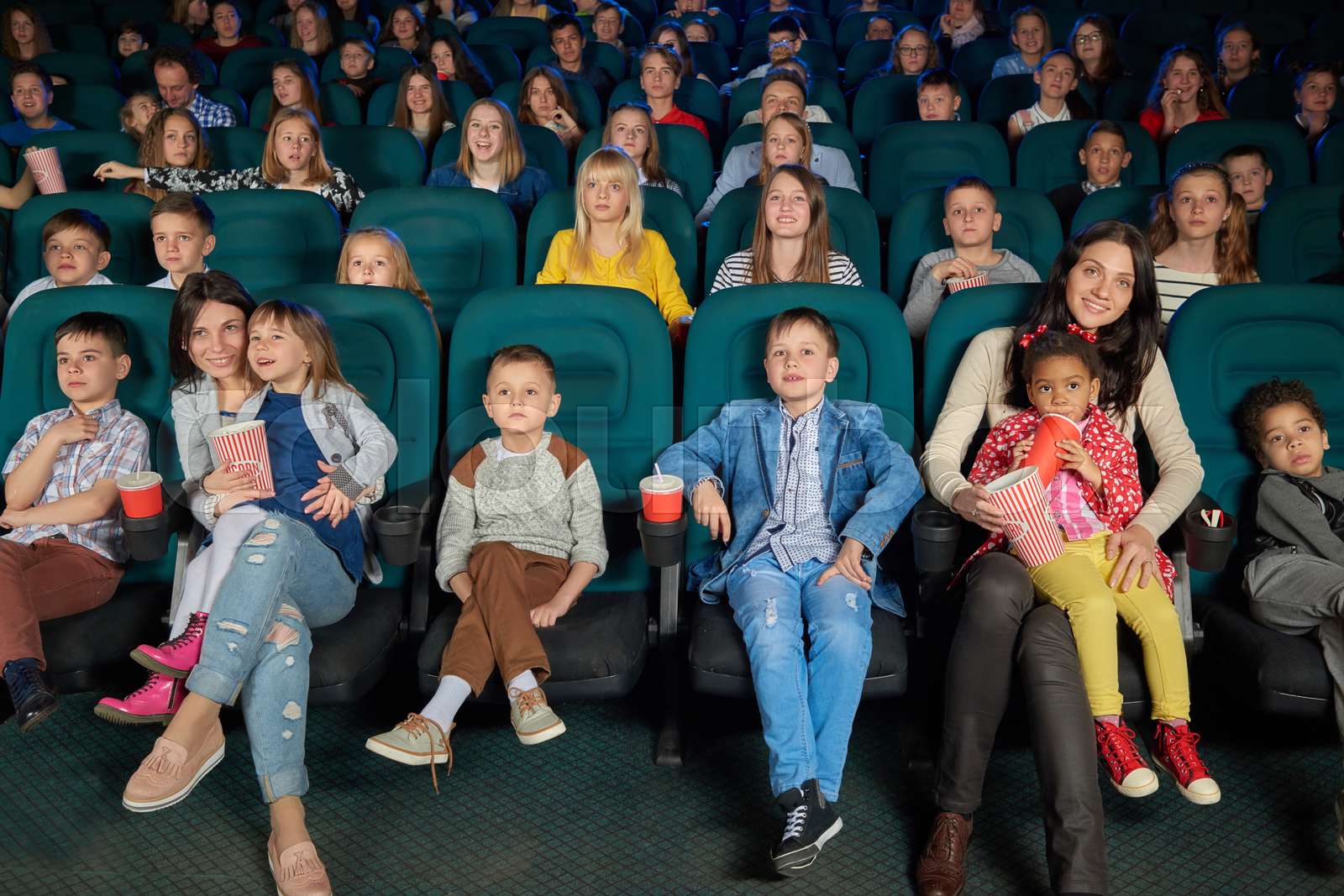Cinema auditorium full of kids during movie premiere | Stock image ...
