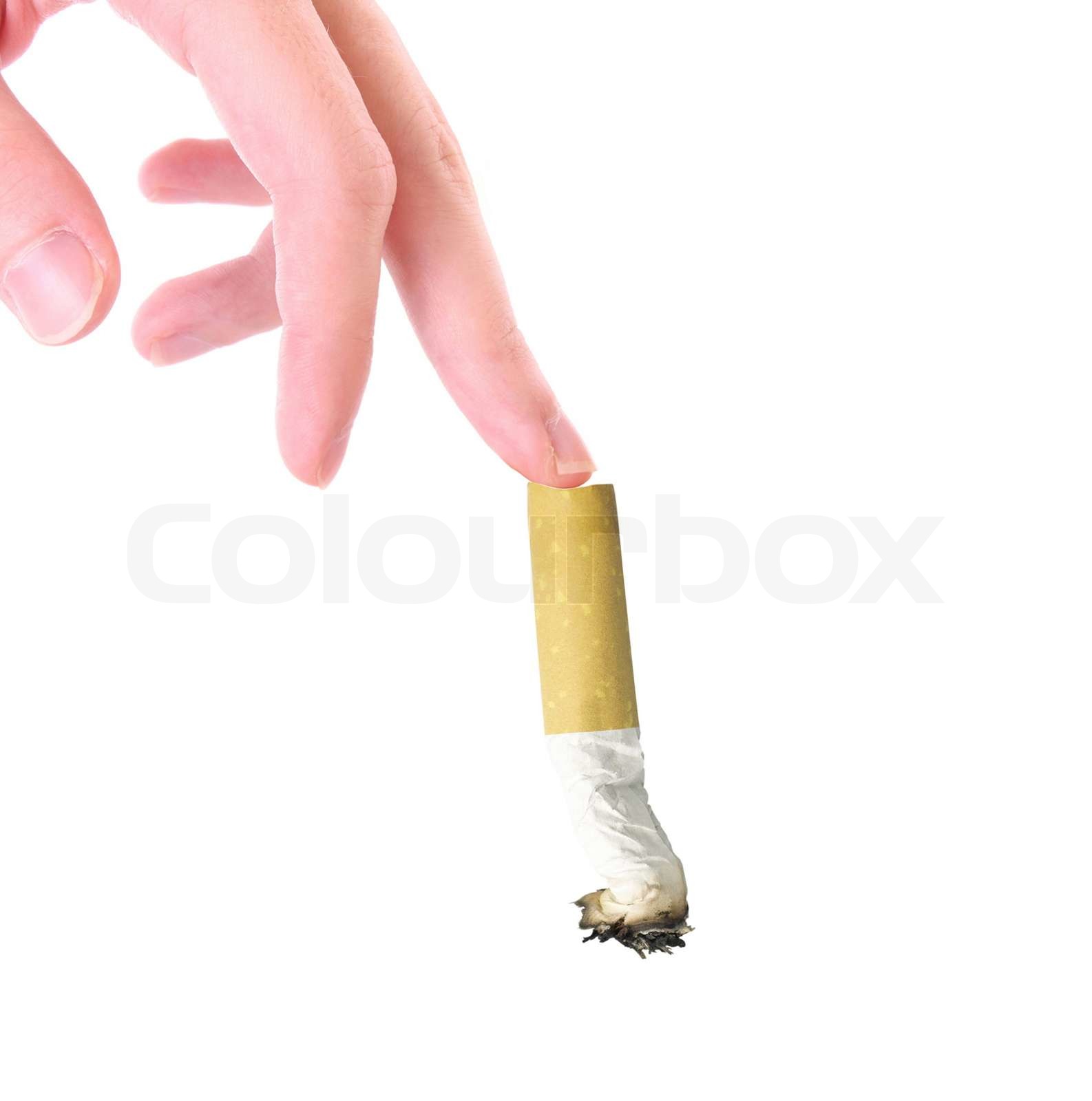 Cigarette in a hand on the white | Stock image | Colourbox