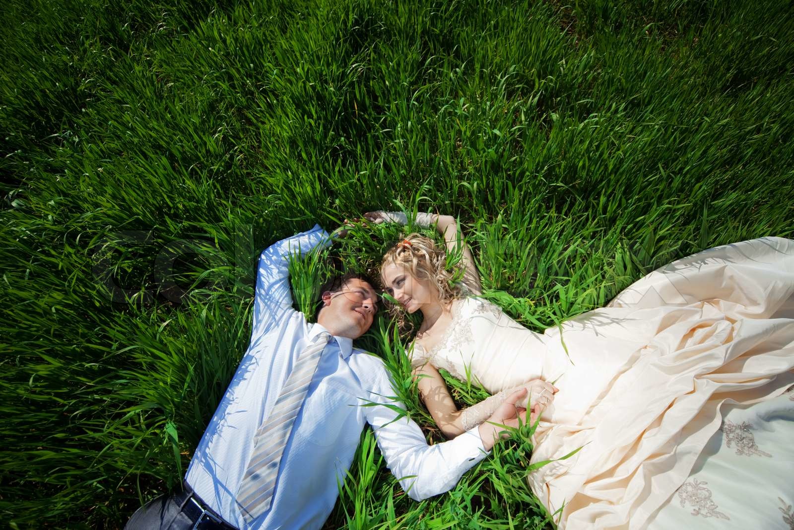Wedding couple in grass | Stock image | Colourbox