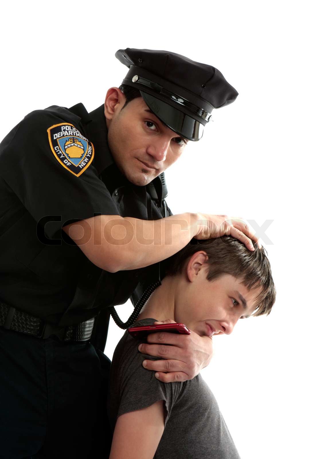 A policeman apprehends a male teen thief | Stock image | Colourbox