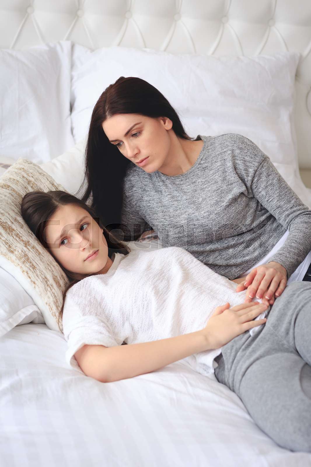 Supportive Mother Helping Her Worried Teenage Daughter Stock Image