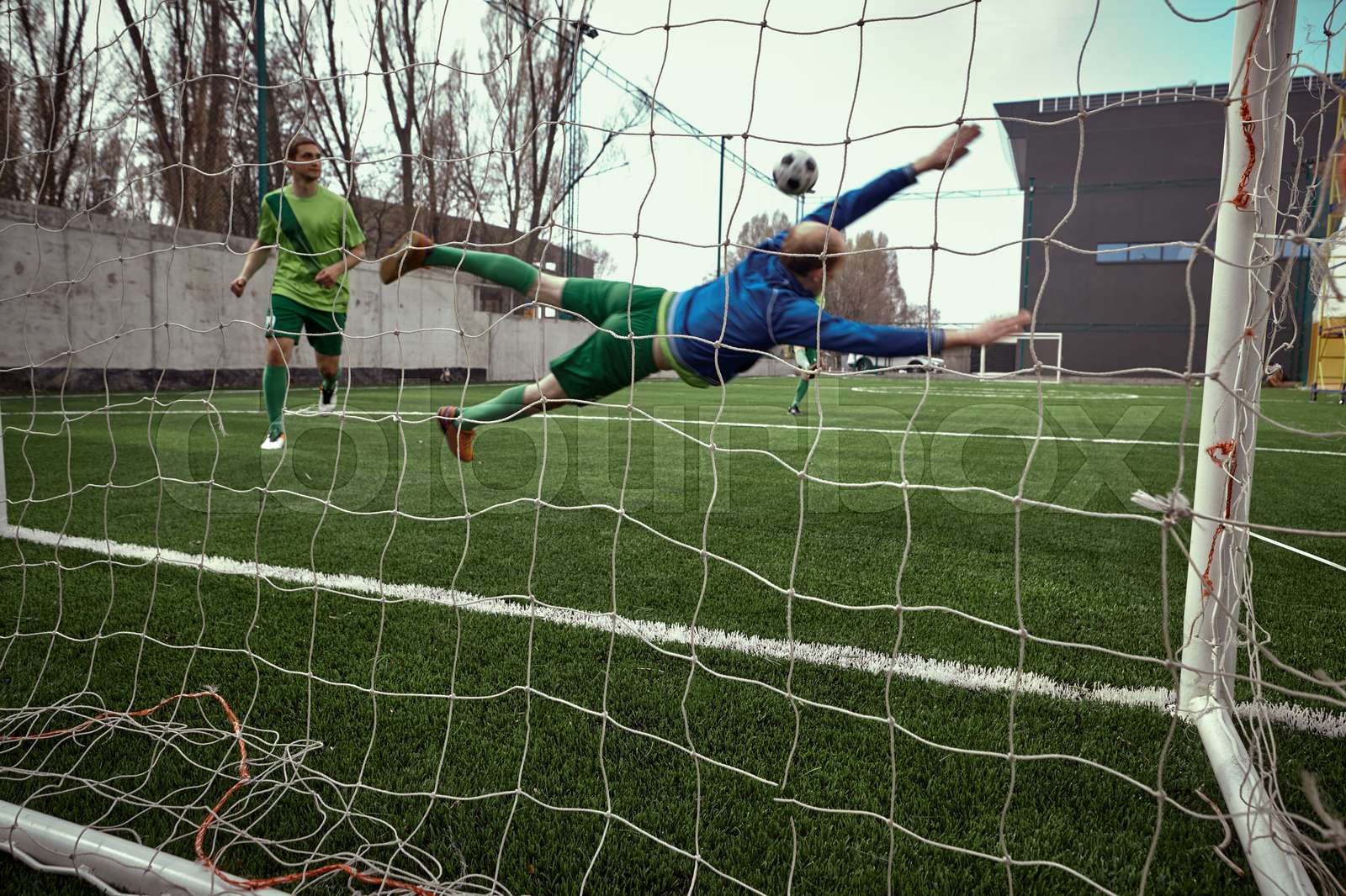 Soccer football goalkeeper making diving save | Stock image | Colourbox