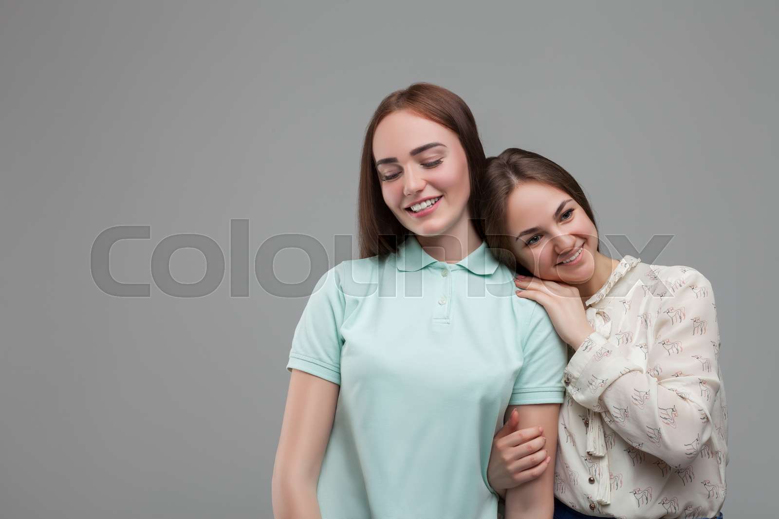 Two women hugs together, studio photo shoot | Stock image | Colourbox