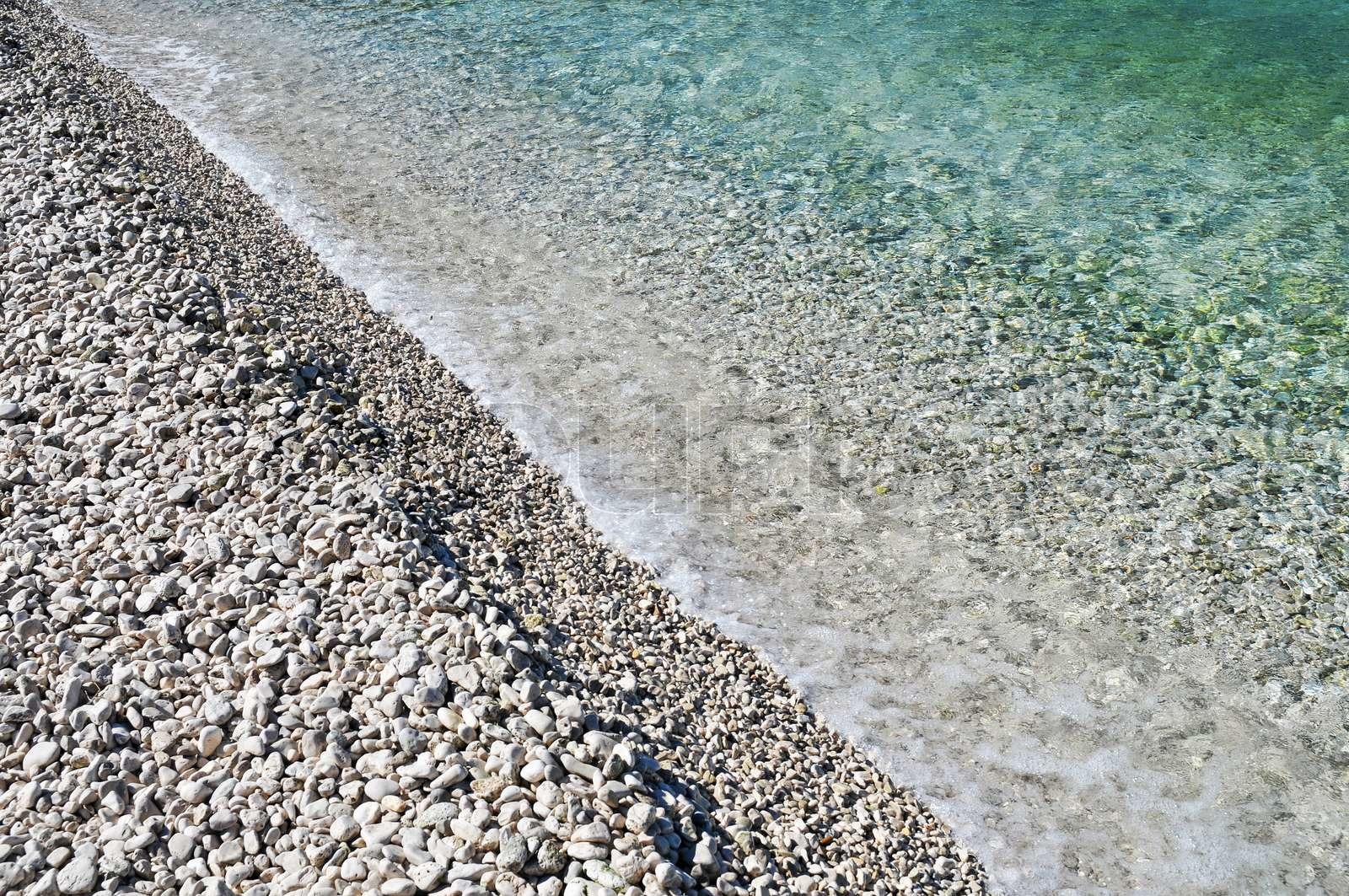 Beach - white pebbles and crystal clear water | Stock image | Colourbox