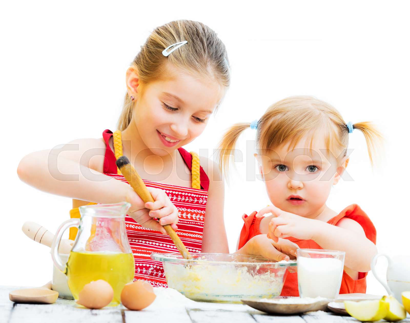 sisters cooking on white | Stock image | Colourbox