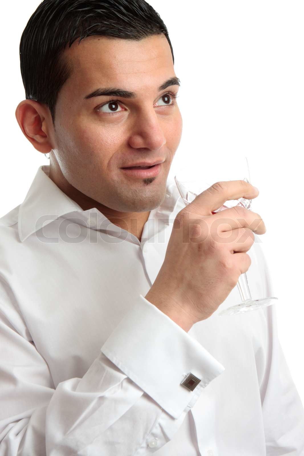 Cheerful hopeful optimistic man holding wine glass and looking sideways ...