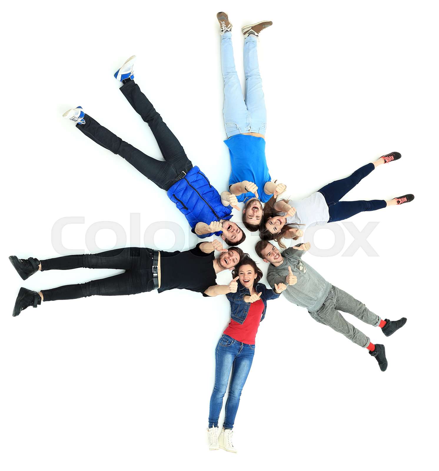 Young people lying down,gesturing thumb up sign | Stock image | Colourbox