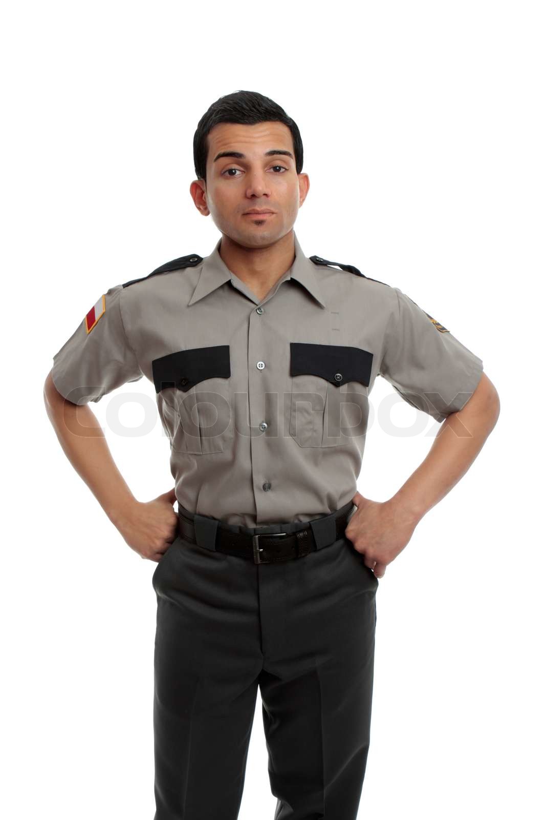 Prison guard, warden, or cop standing firm with hands on hip | Stock ...