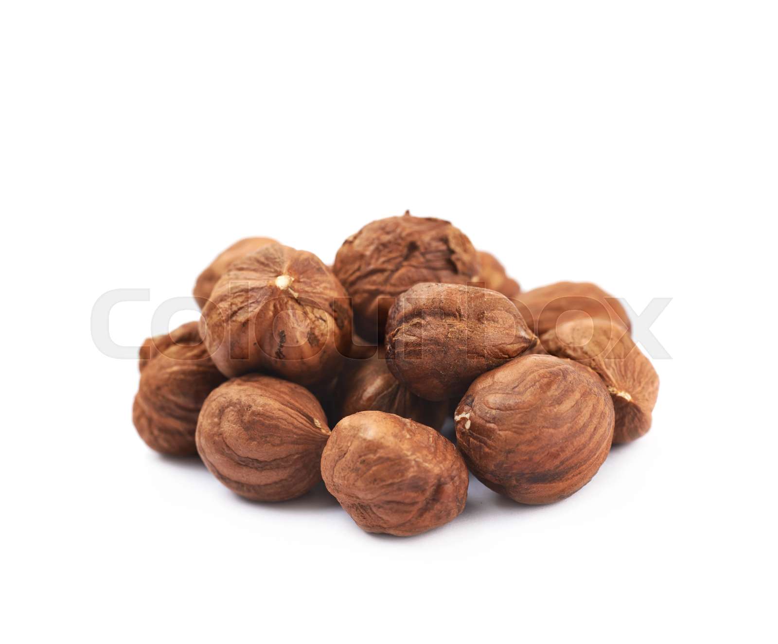 Pile of hazelnuts isolated | Stock image | Colourbox