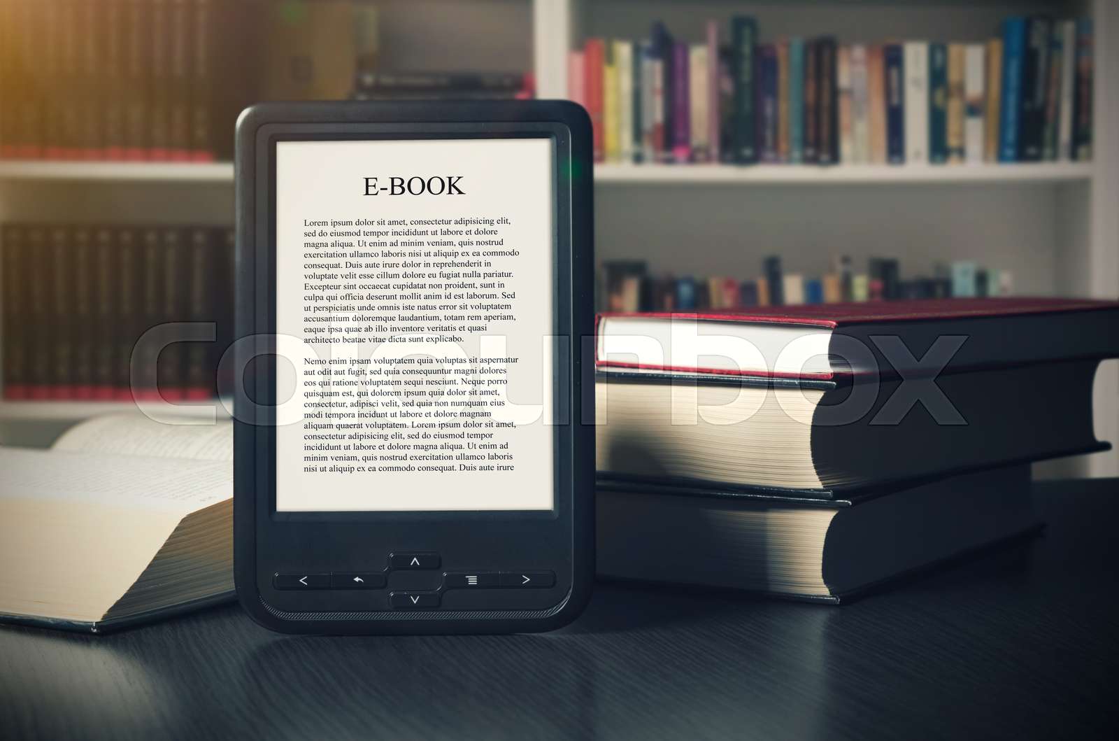 E-book reader device on desk in library | Stock image | Colourbox