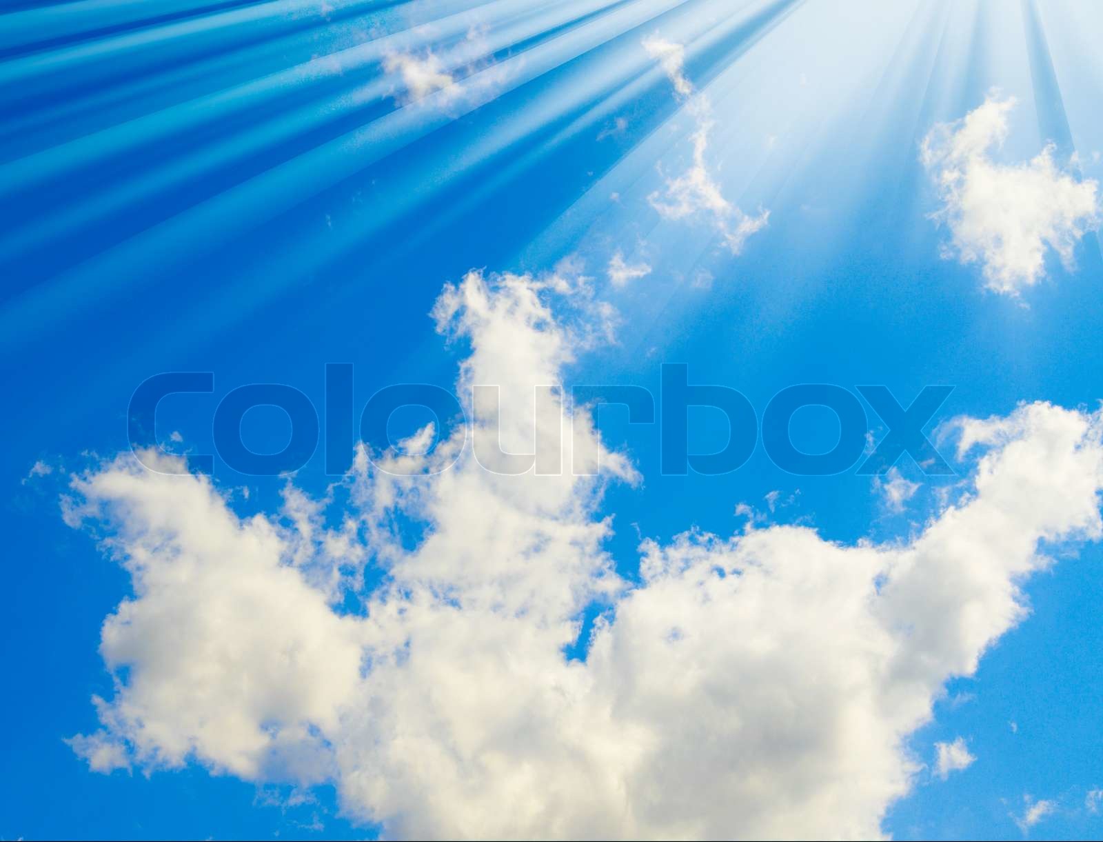 Sunbeams and clouds on blue sky | Stock image | Colourbox