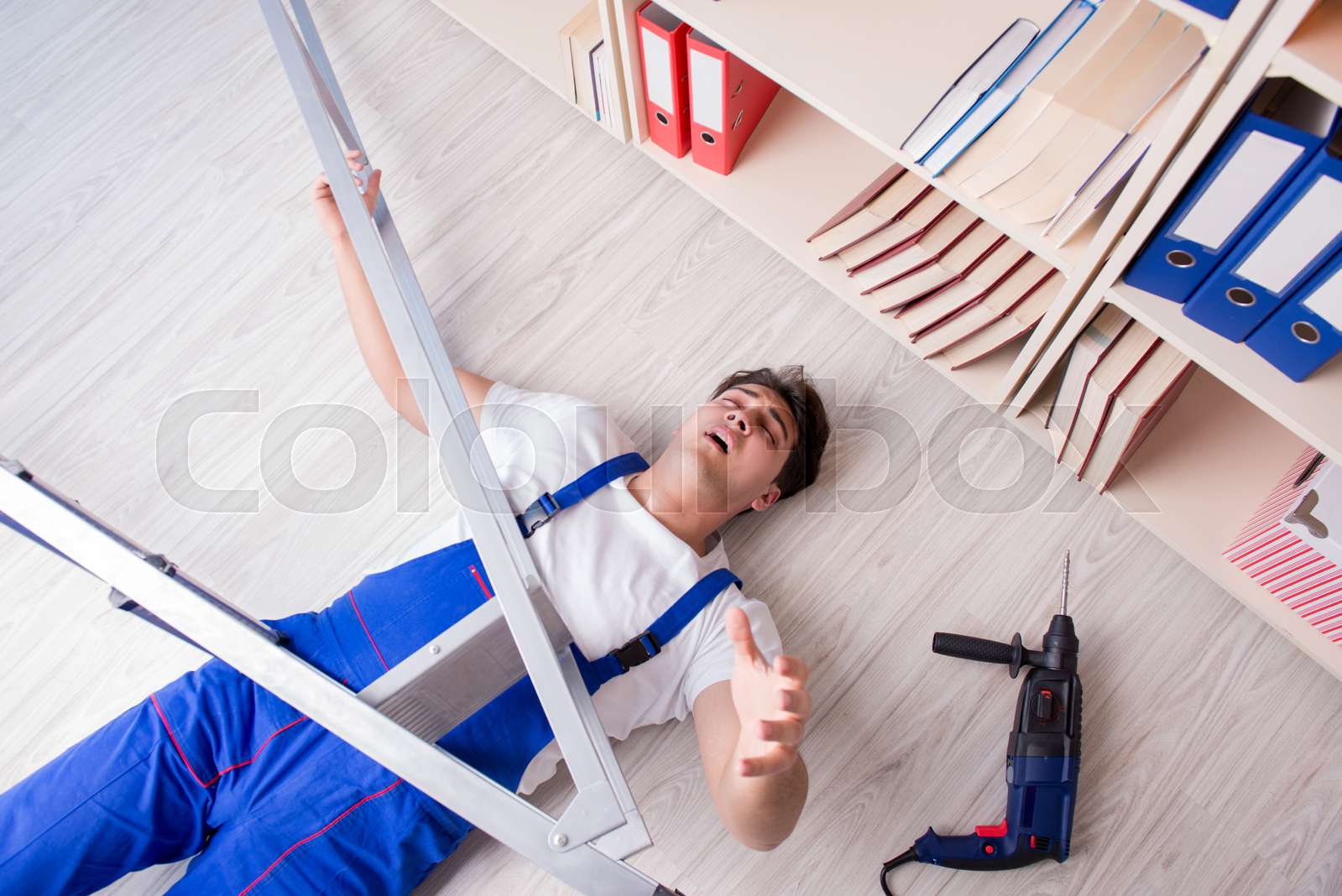 Unsafe behavior concept with falling worker | Stock image | Colourbox