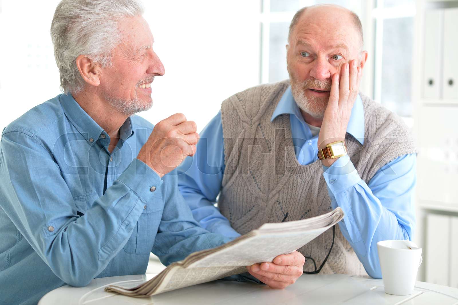 Old men reading a newspaper | Stock image | Colourbox