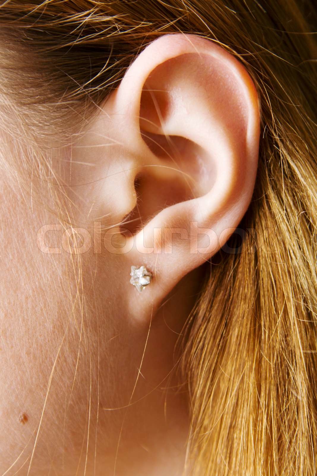Closeup photo of a pretty female ear | Stock image | Colourbox