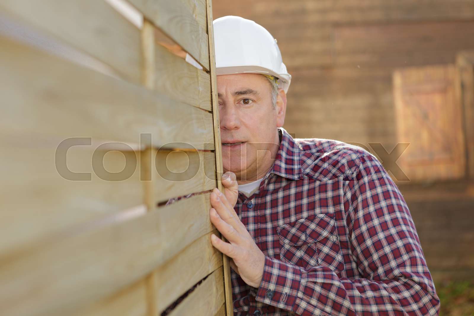 builder lining up cargo boxes outdoors a construction site | Stock ...