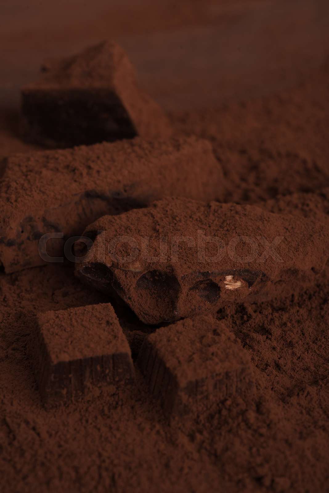 Dark crashed chocolate bar covered in powder | Stock image | Colourbox