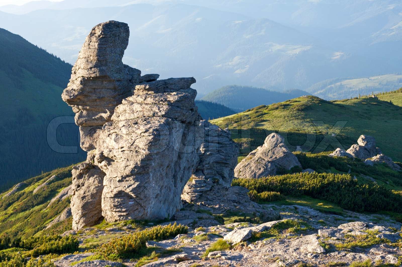 Big stony figure in human face form on mountain ridge | Stock image ...