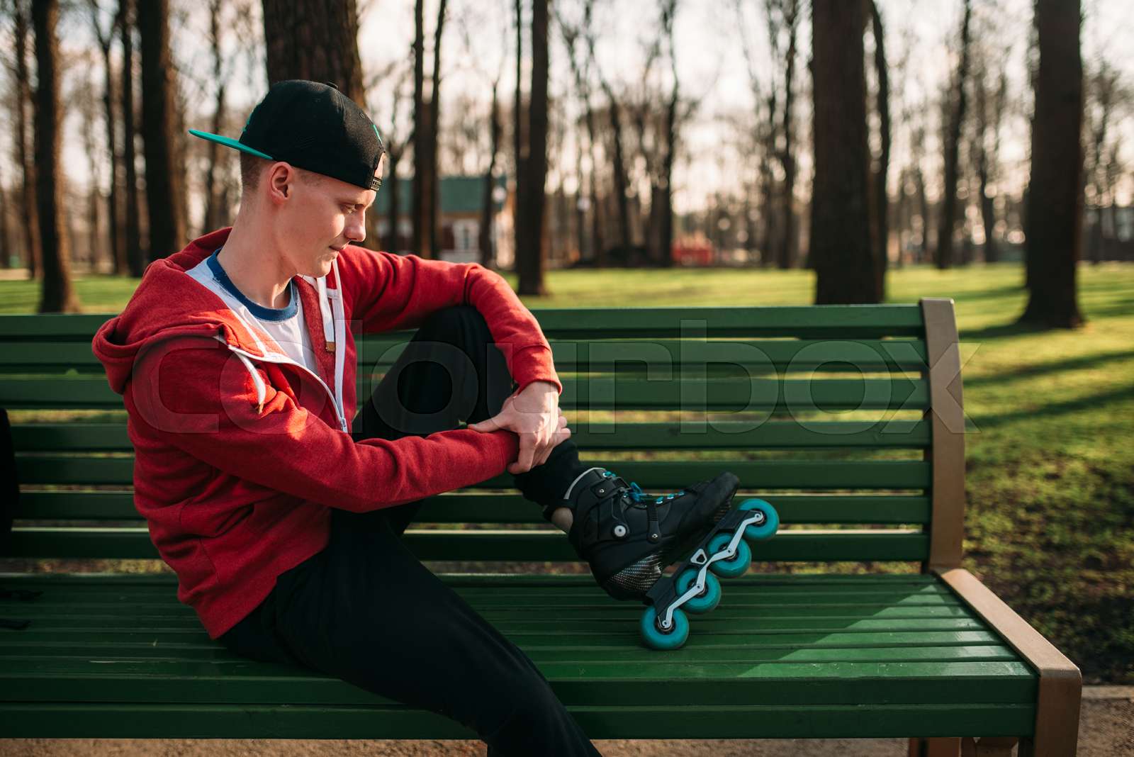 Roller skater posing on the bench in skates | Stock image | Colourbox