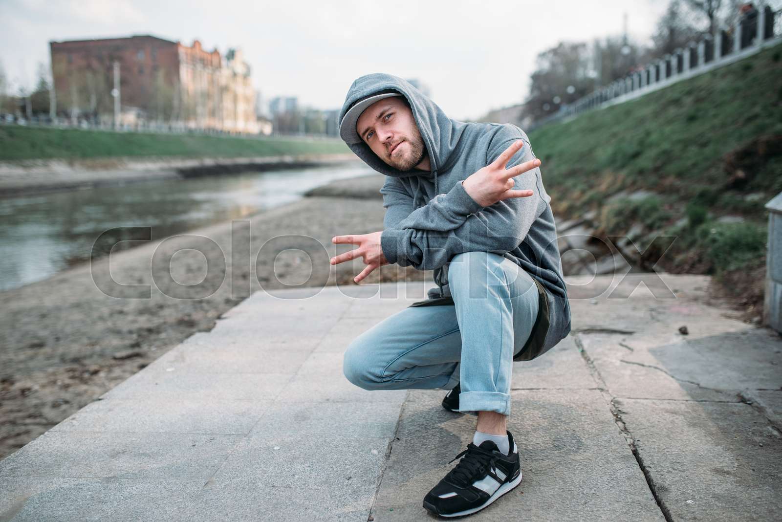 Male rapper posing on the street, urban dancing | Stock image | Colourbox