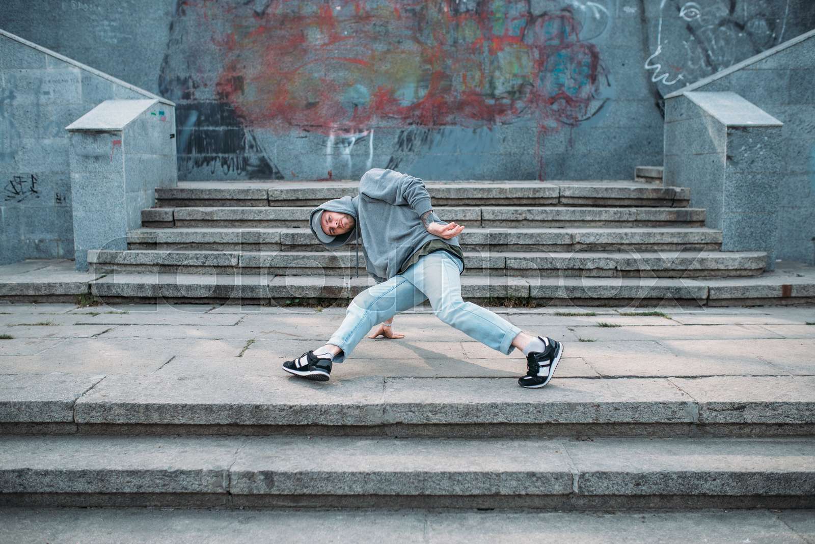 Male rapper posing on the street, urban dancing | Stock image | Colourbox