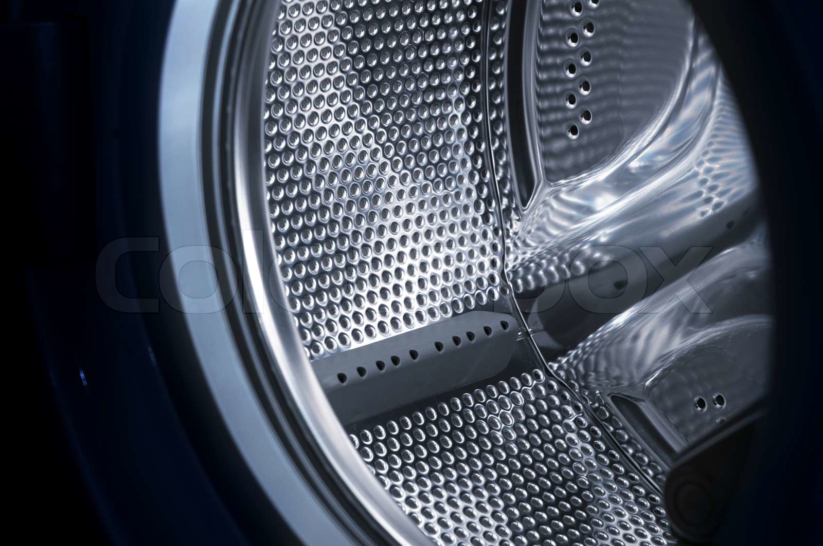 This photograph represent a modern washing machine drum interior ...
