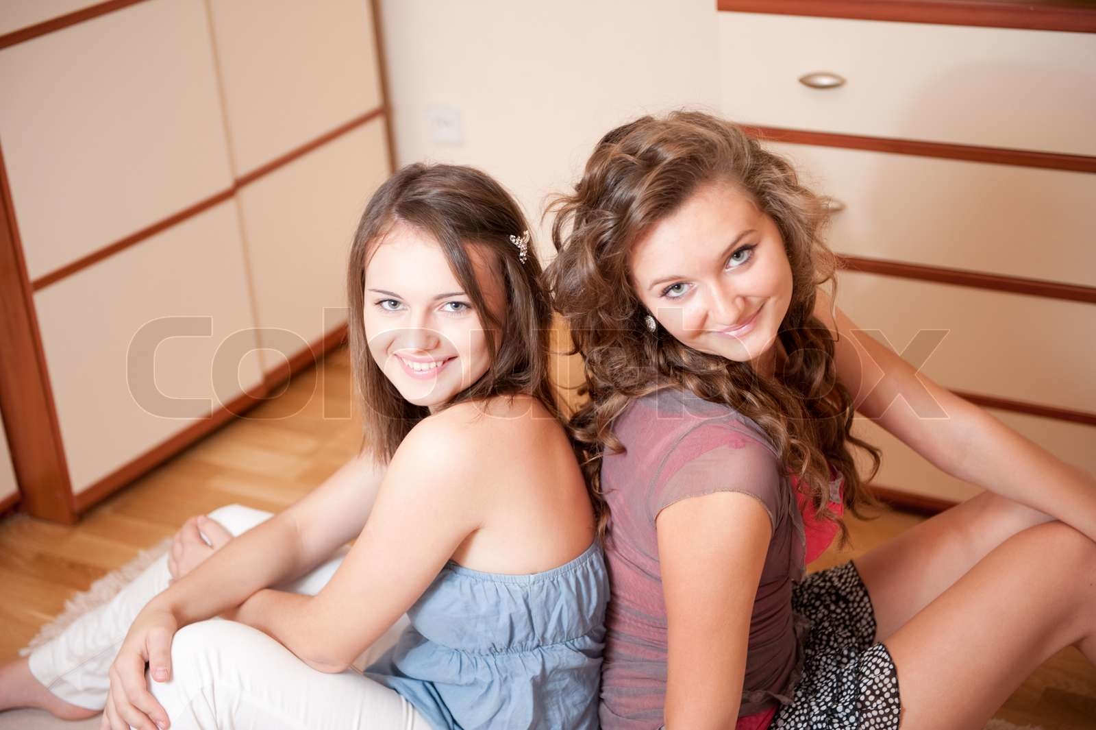 Two Young Girls Sitting On The Floor Stock Image Colourbox 8673