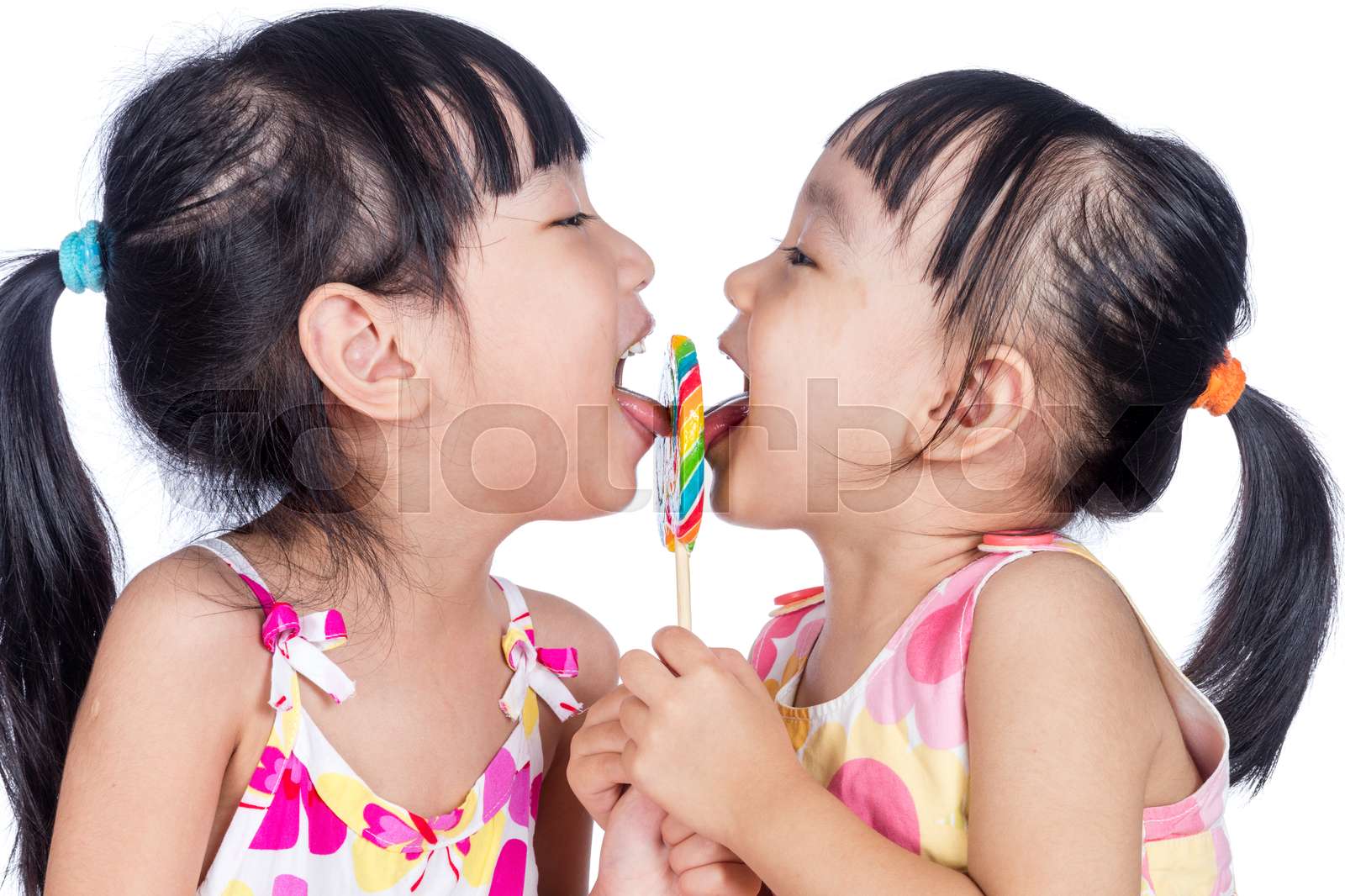 Asian Little Chinese girls eating lollipop | Stock image | Colourbox