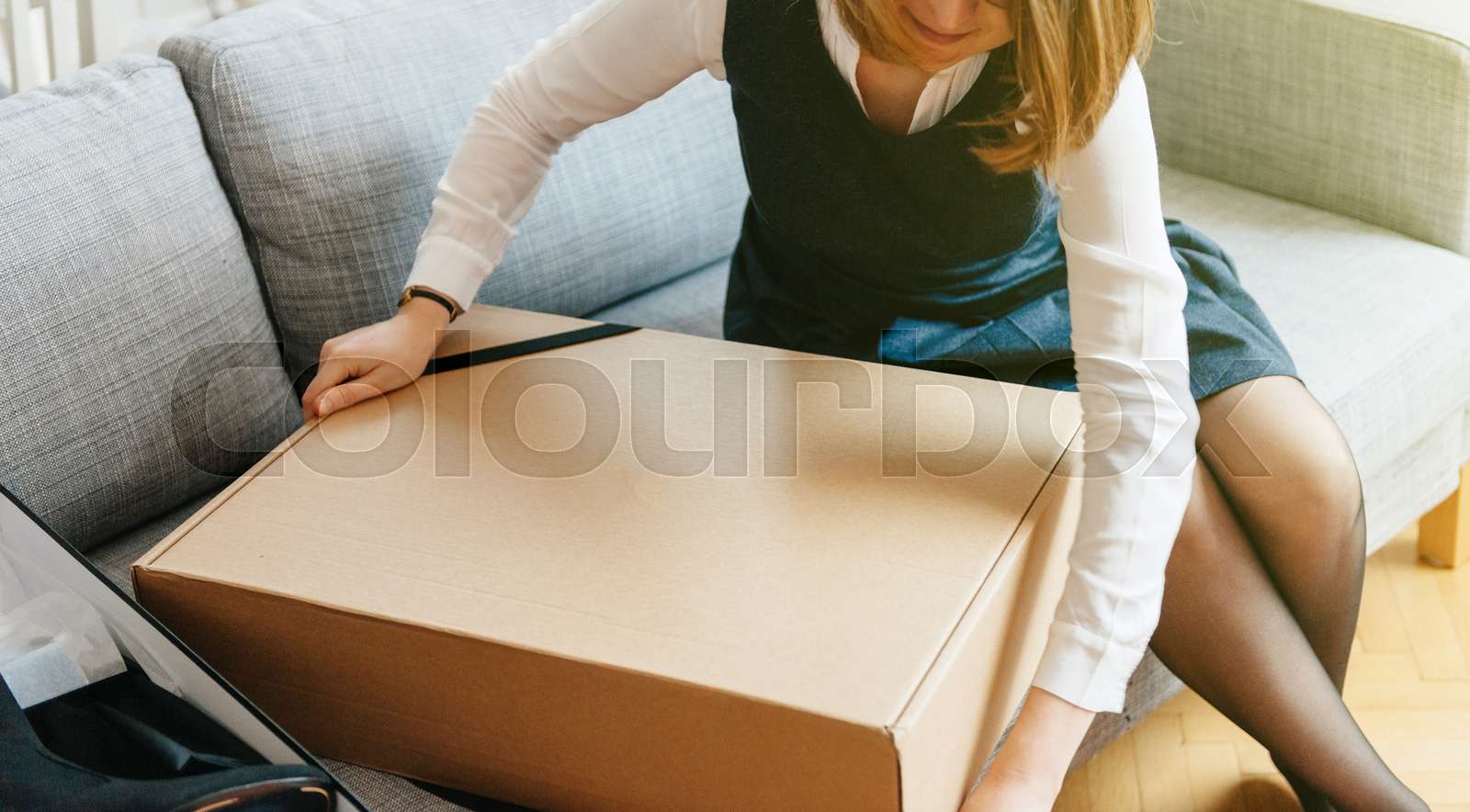 Woman unpacks unboxing new parcel containing fashion clothes | Stock ...