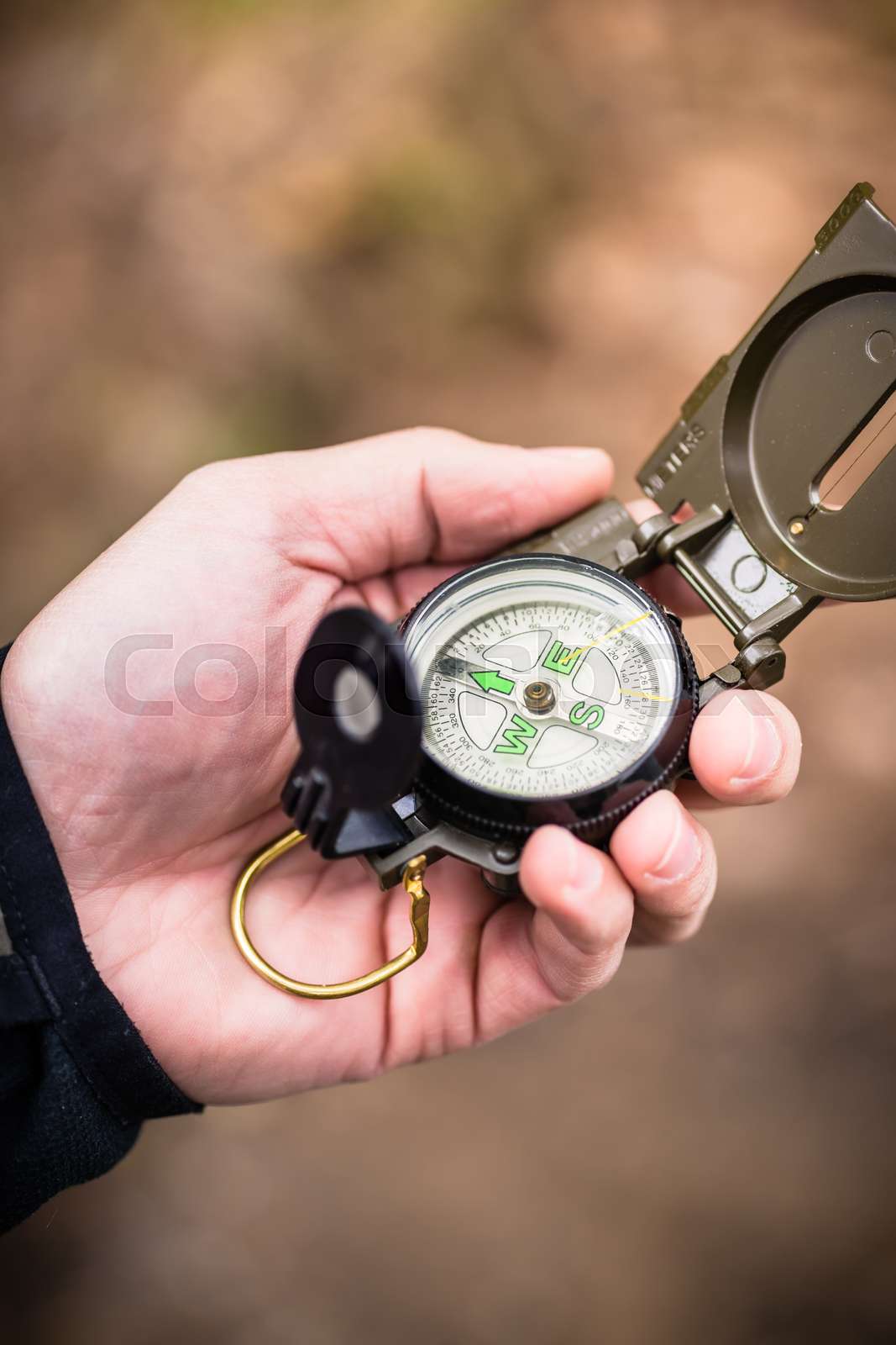 Hiker using compass | Stock image | Colourbox