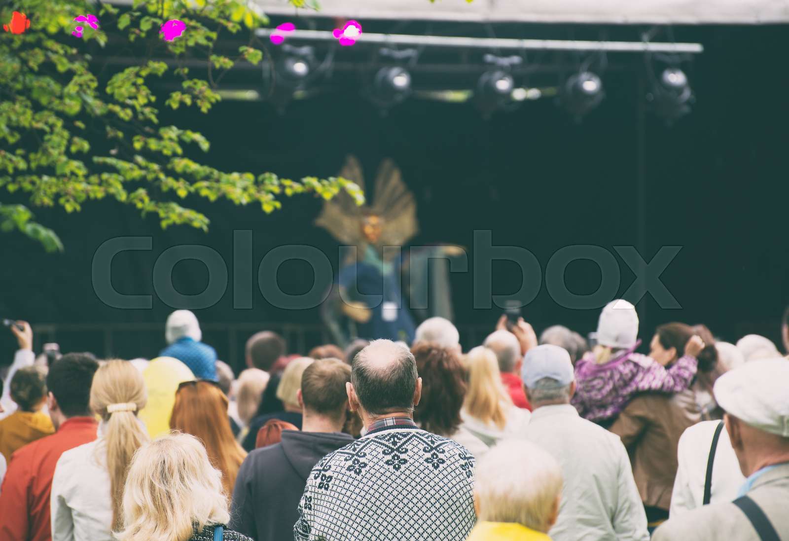 People watching live performance on stage. | Stock image | Colourbox