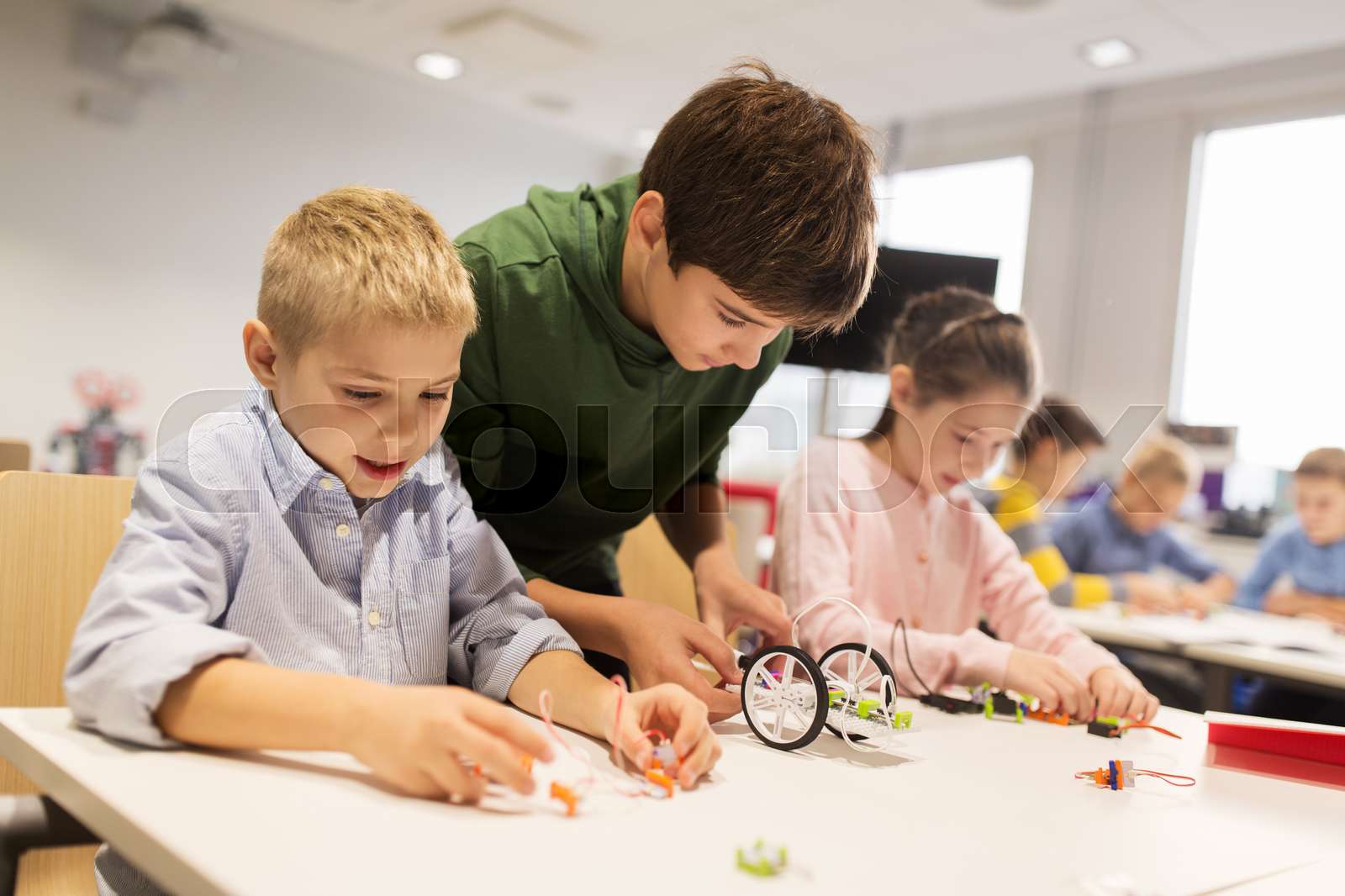 happy children building robots at robotics school | Stock image | Colourbox