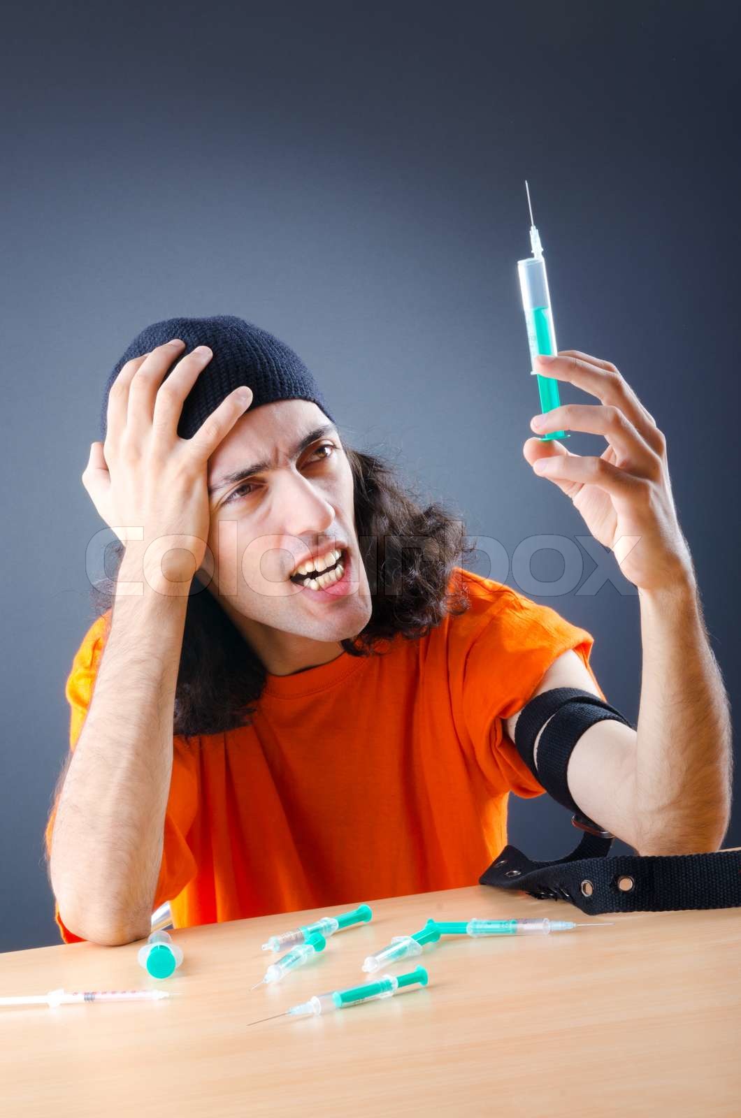 Young druc addict with syringe | Stock image | Colourbox