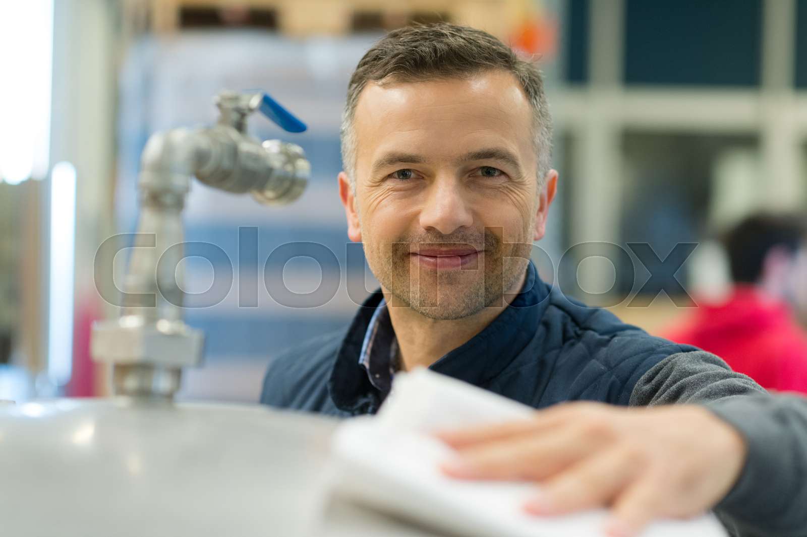 employee wiping the product | Stock image | Colourbox