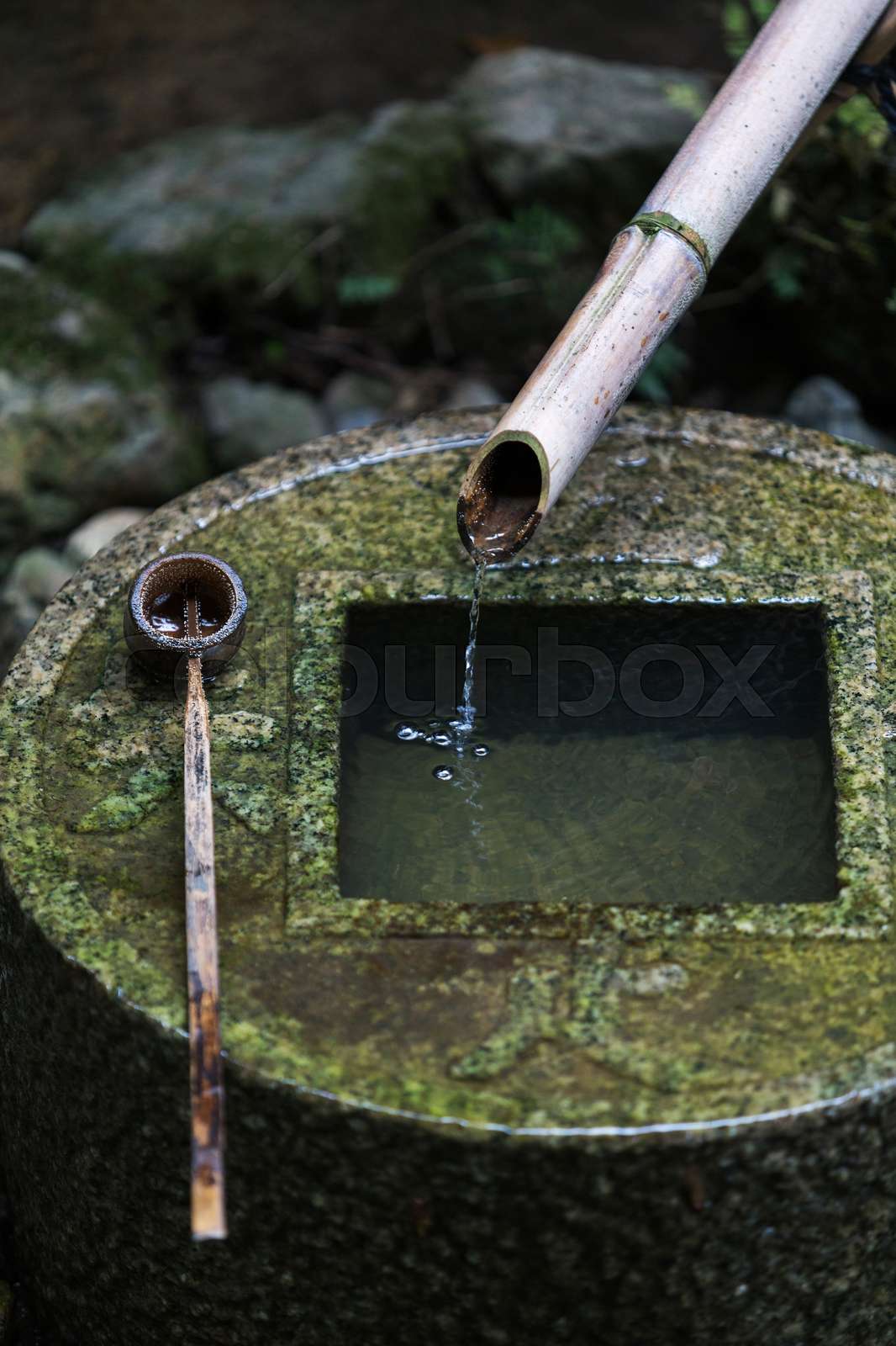 Japanese style traditional bamboo fountain and stone basin for hand ...