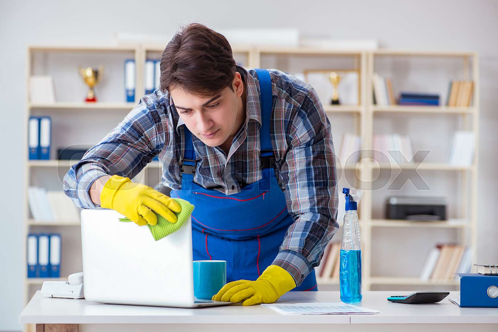Male cleaner working in the office | Stock image | Colourbox