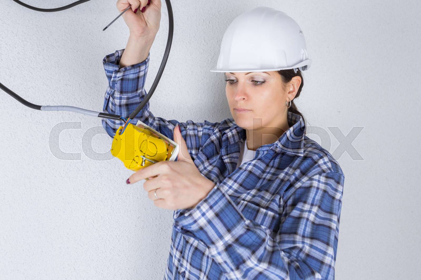 woman fixing central heating thermostat | Stock image | Colourbox
