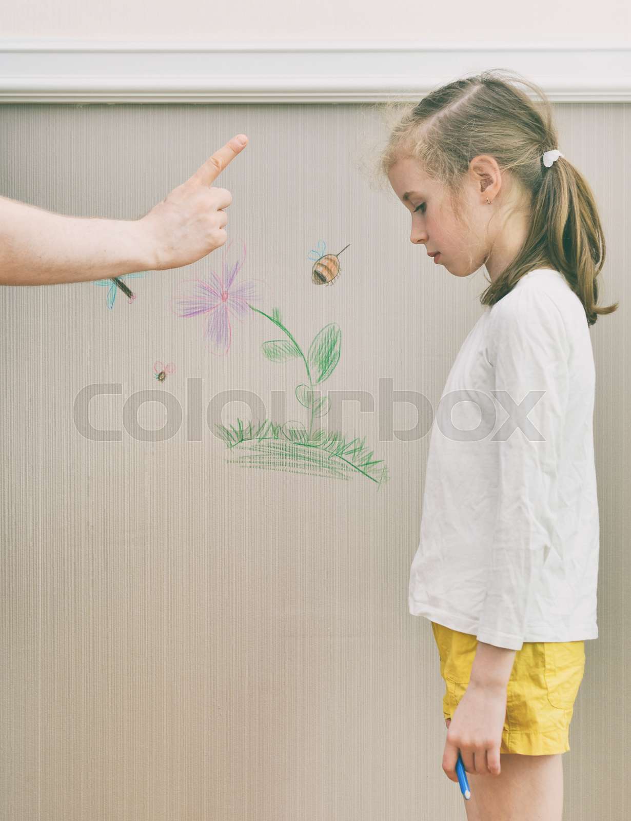 Little girl spoiled the wallpaper and her dad is angry. | Stock image ...