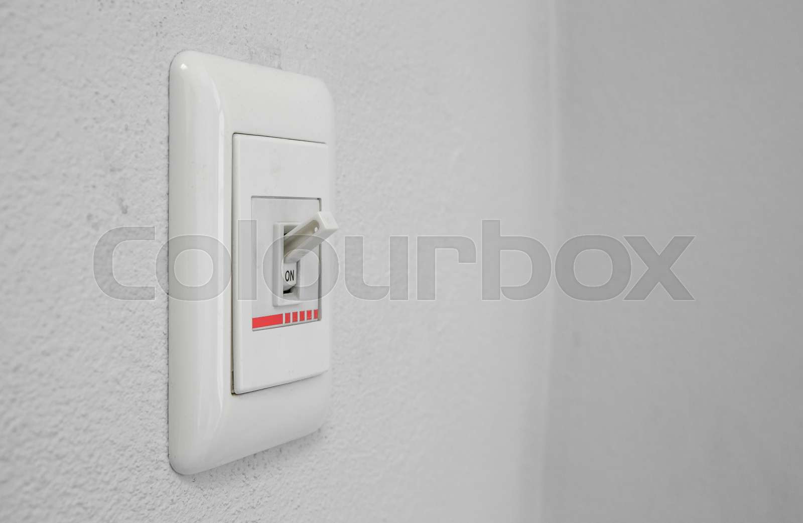 wall light switch in the on position | Stock image | Colourbox