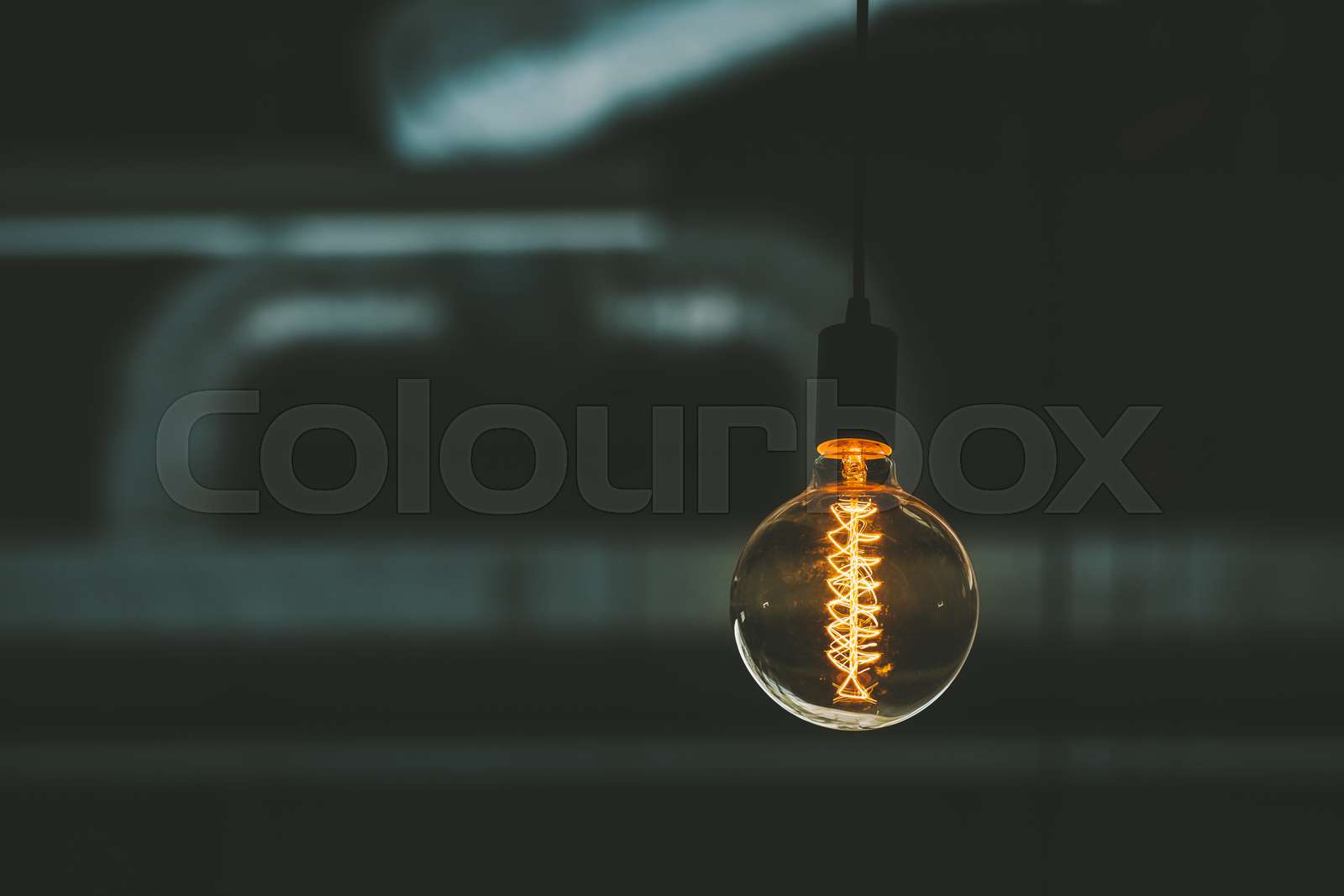 vintage edison light bulb hanging in dark room with copy space | Stock ...