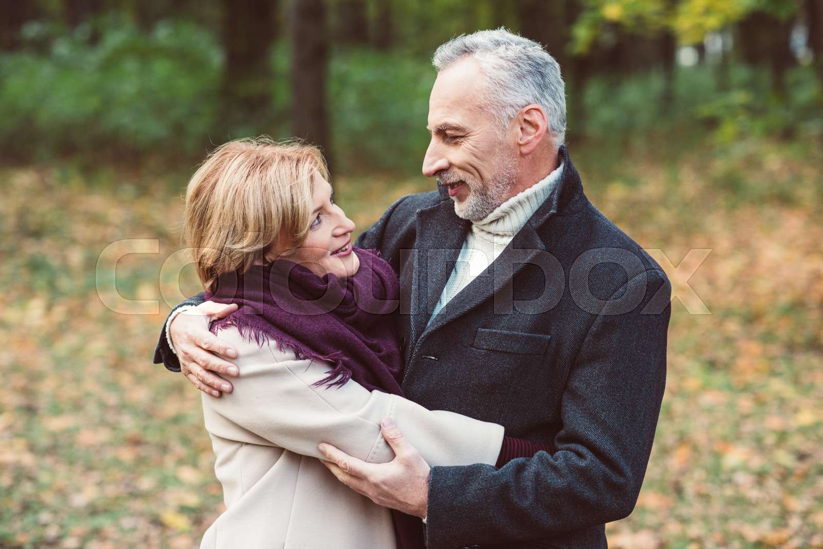Mature couple embracing in park | Stock image | Colourbox