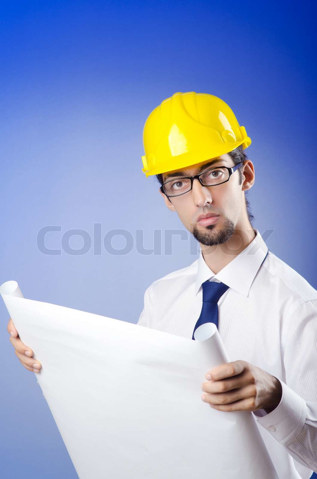 Young engineer looking at drawings | Stock image | Colourbox