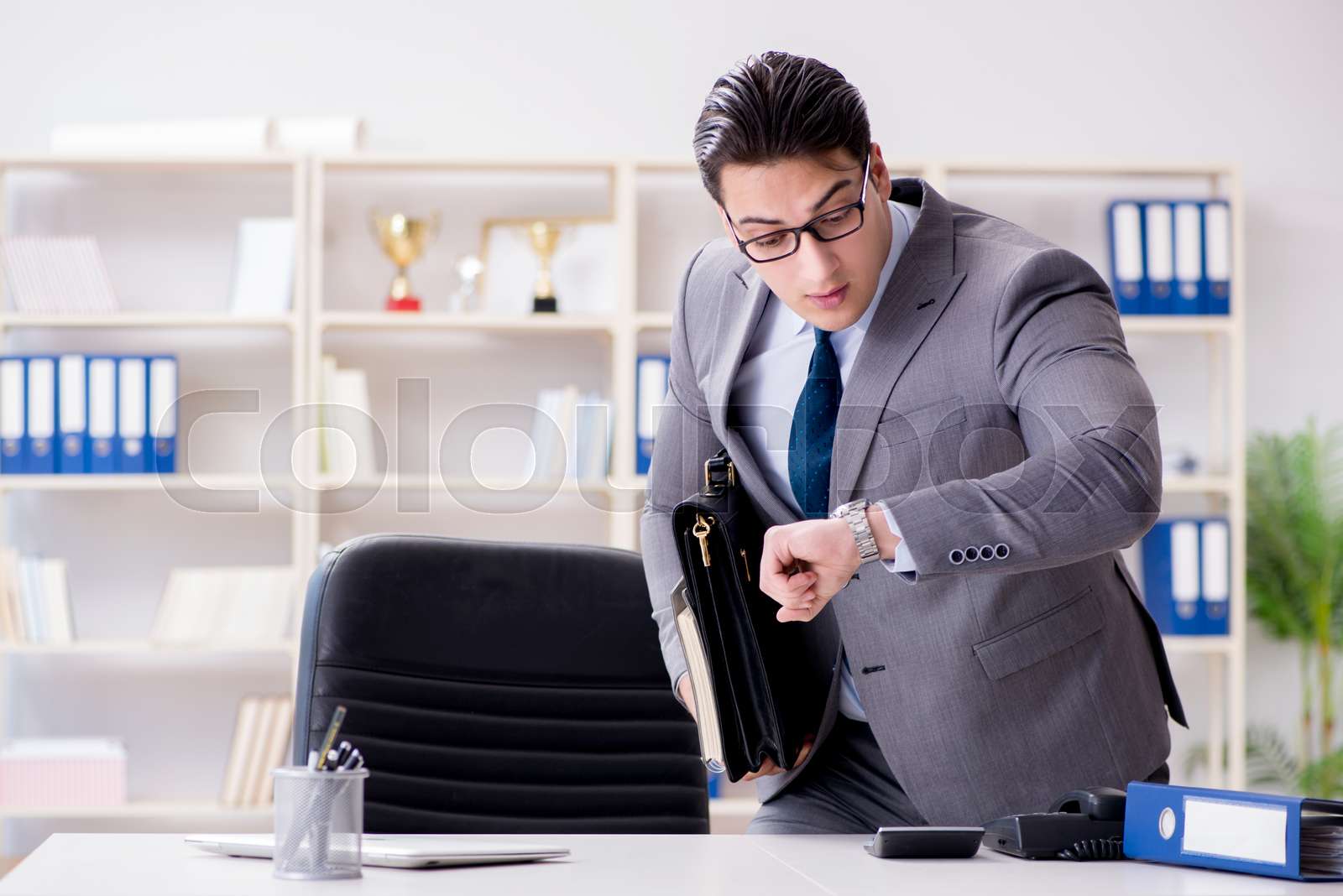 Businessman rushing in the office | Stock image | Colourbox