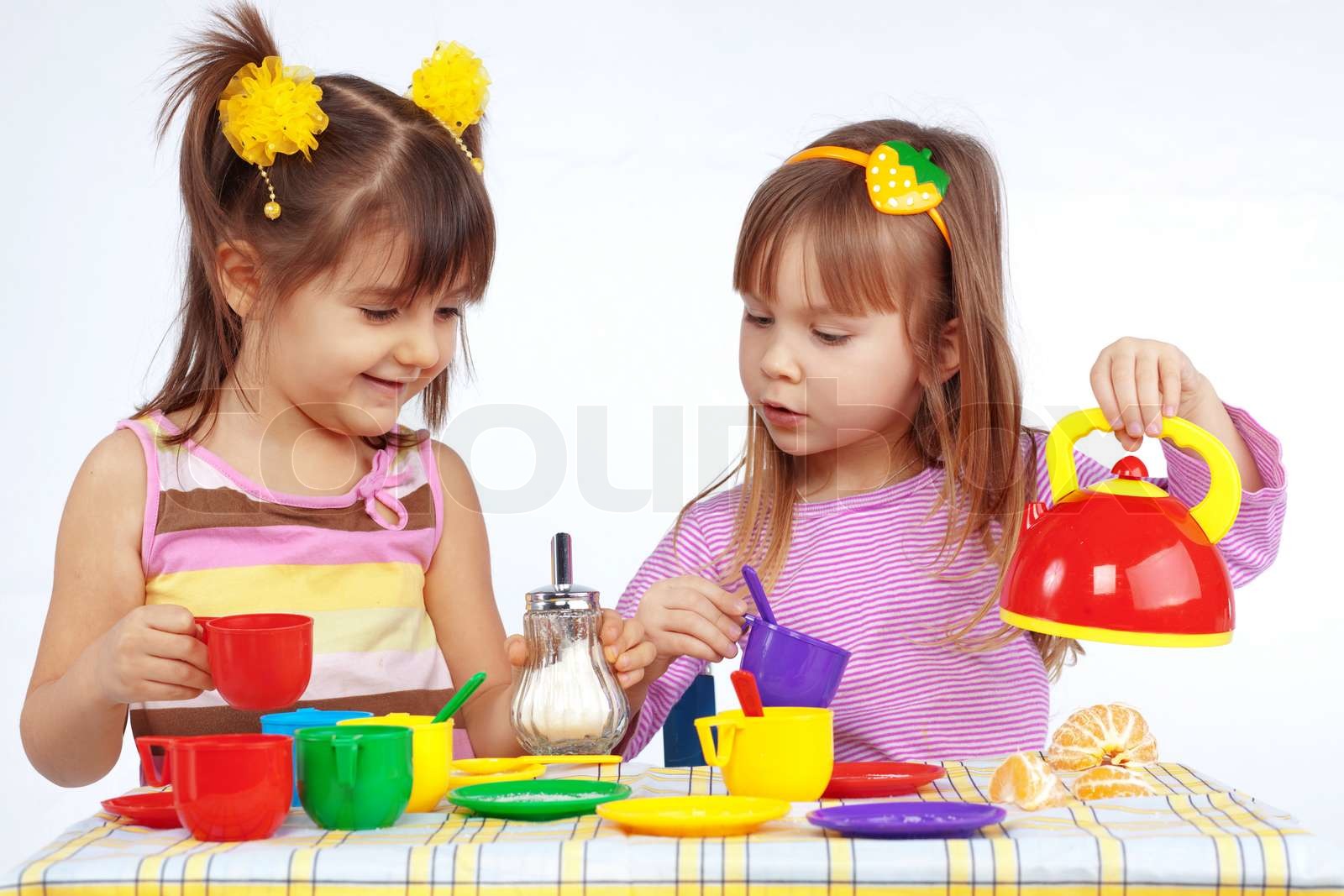 Kids playing with plastic tableware | Stock image | Colourbox